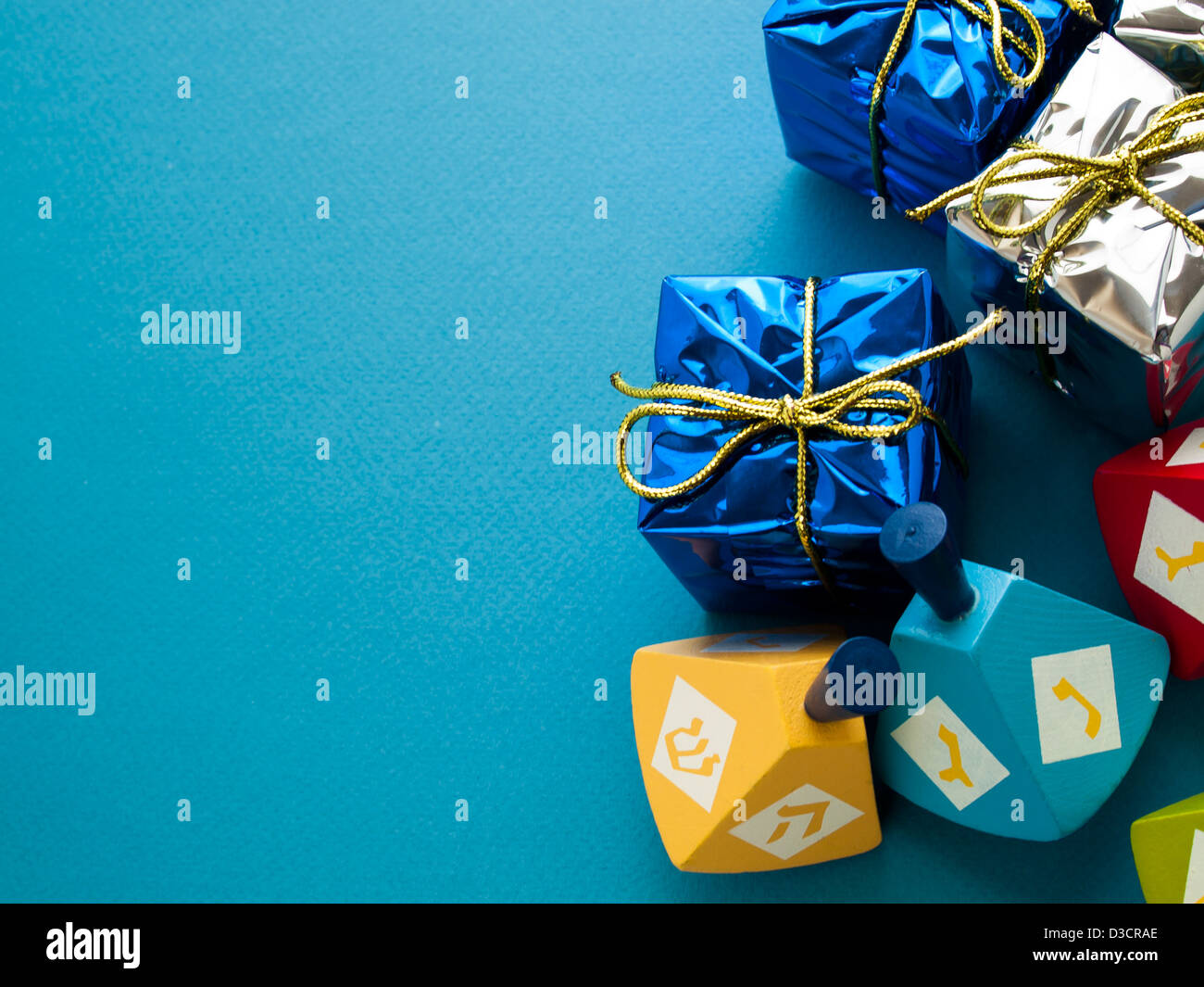 Colorful dreidels with presents on blue background Stock Photo - Alamy