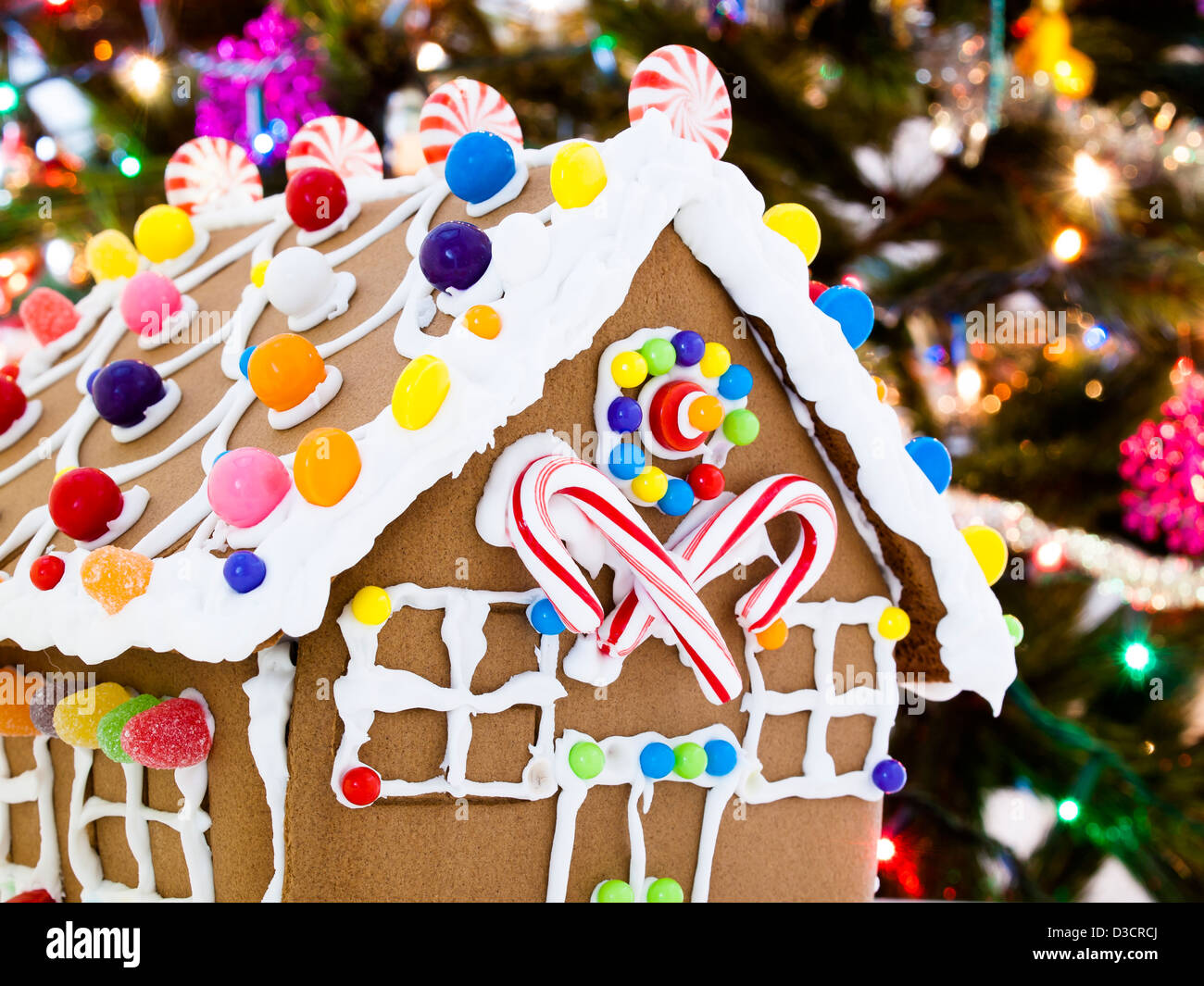 Gingerbread house decorated with candies with Christmas tree in the ...