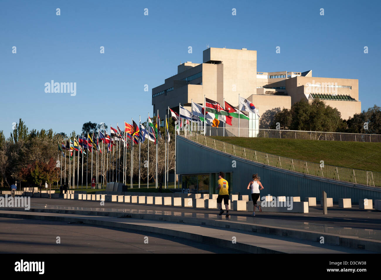 Joggers passing the United Nations flags in front of the High Court of ...