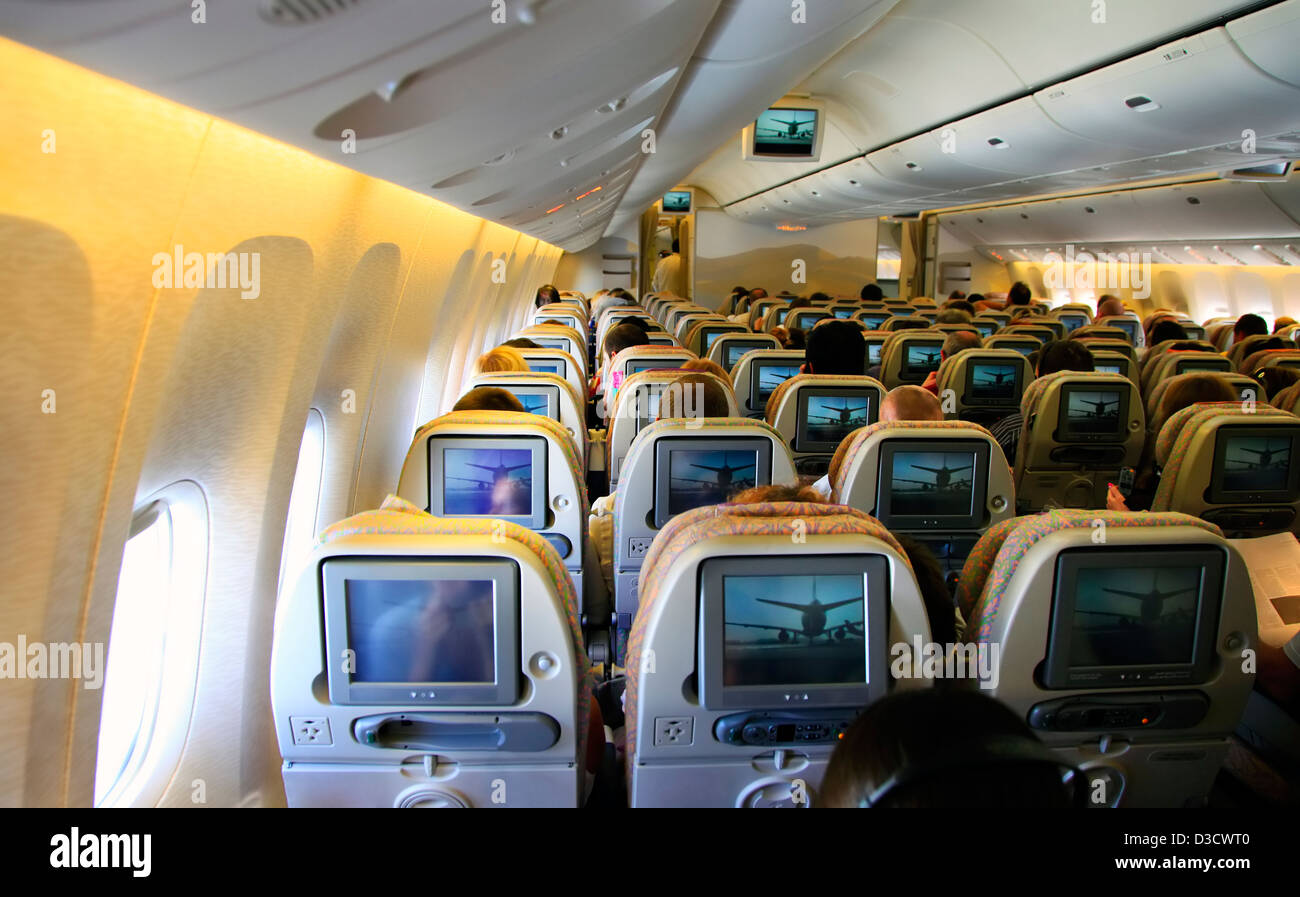 In-flight image of an airplane interior with passengers Stock Photo - Alamy