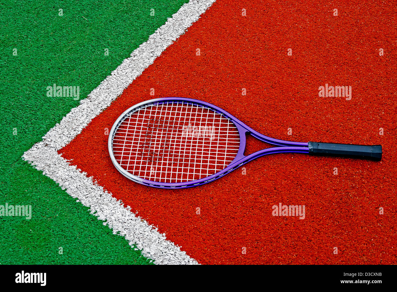 Tennis racket, placed in the corner of a synthetic field Stock Photo ...