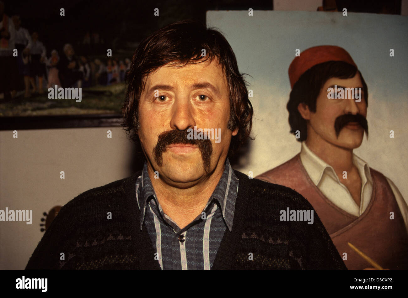 A Croatian man poses with his own painted portrait in a village in ...