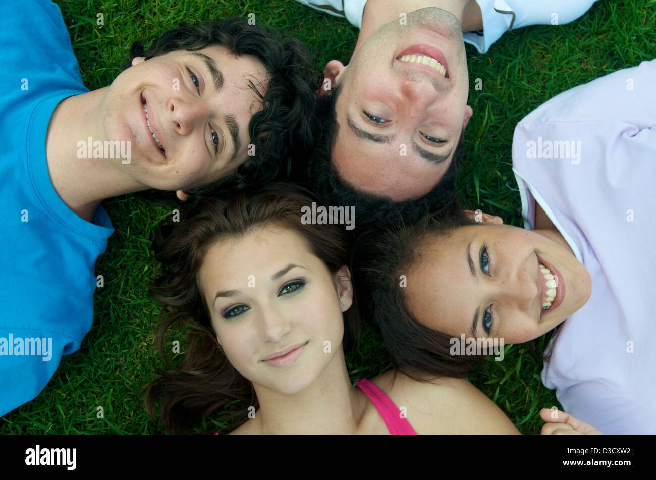 Friends lying on the ground Stock Photo - Alamy