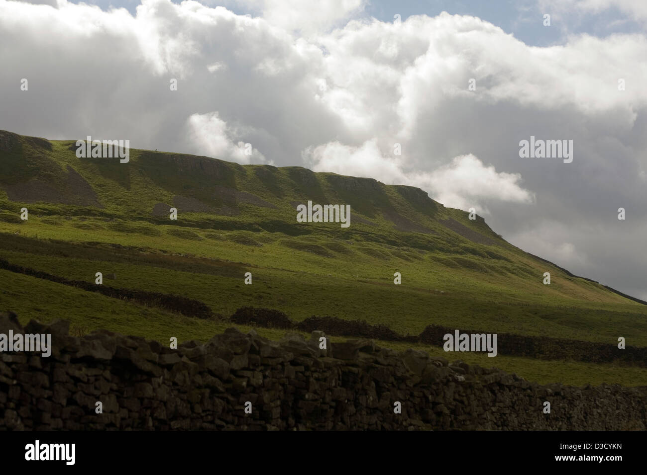 Storm clouds rising above Penhill Beacon above West Witton Wensleydale ...