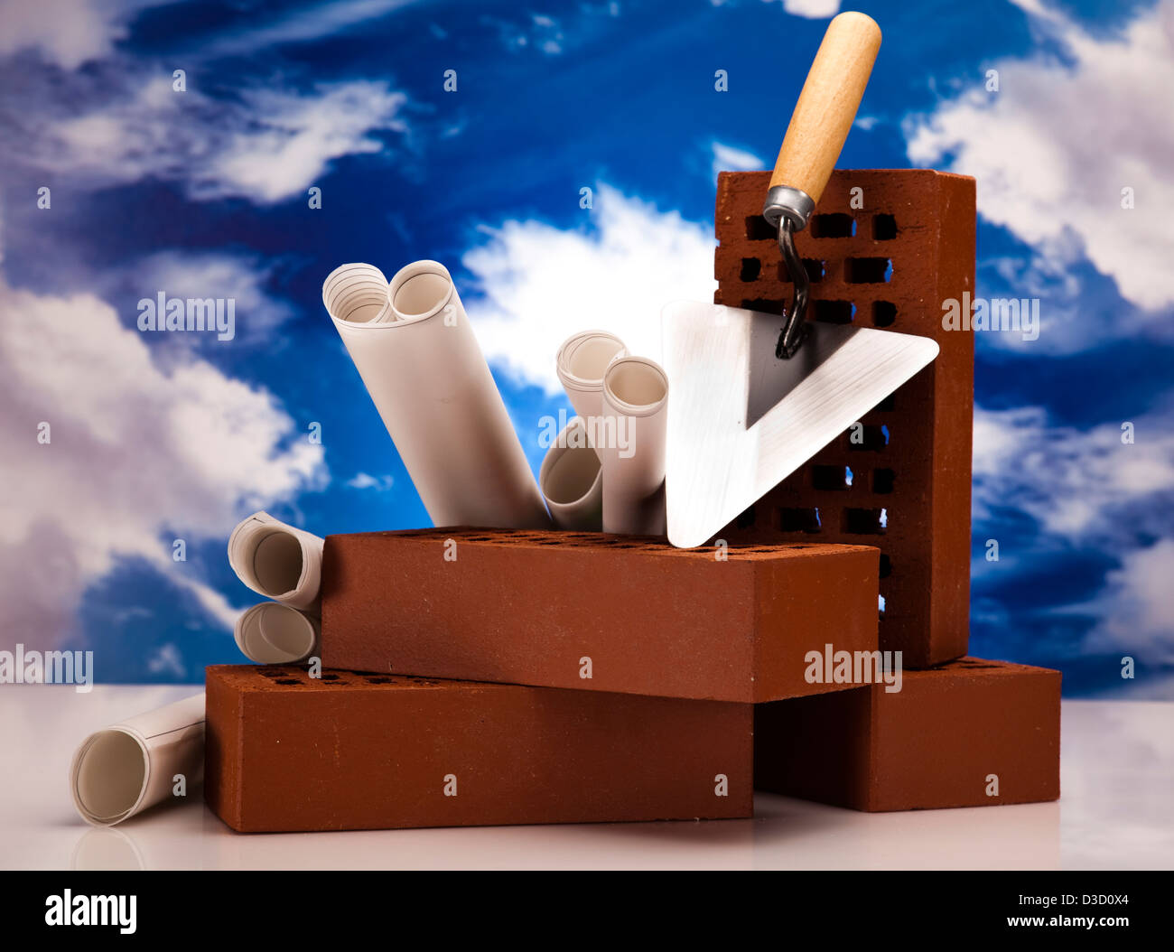 Bricks, trowel tool and Construction plans Stock Photo - Alamy