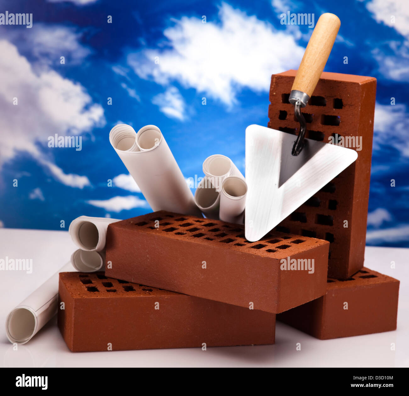 Bricks, trowel tool and Construction plans Stock Photo - Alamy