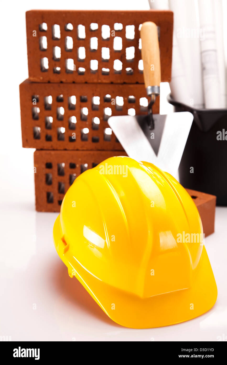 Bricks, trowel tool and Construction plans Stock Photo - Alamy