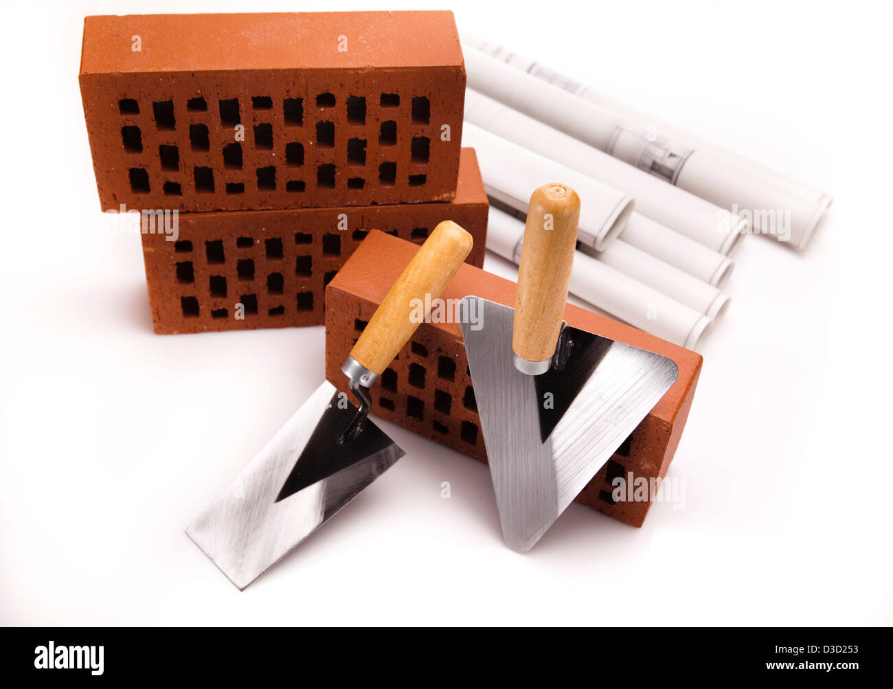 Bricks, trowel tool and Construction plans Stock Photo - Alamy