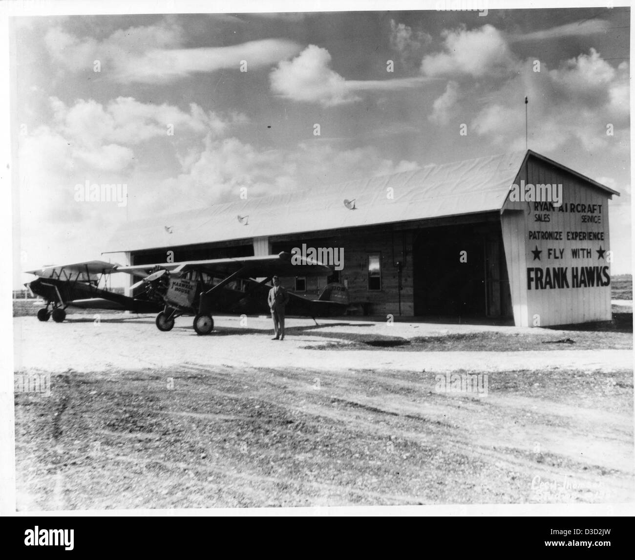This photograph features Frank Hawks, an aviation pioneer, standing ...