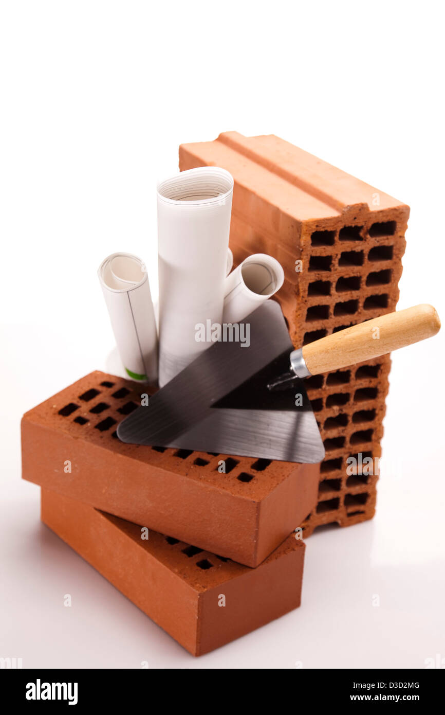 Bricks, trowel tool and Construction plans Stock Photo - Alamy