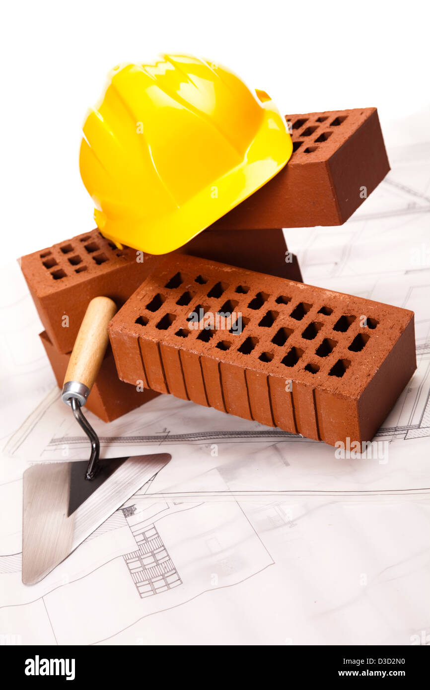 Bricks, trowel tool and Construction plans Stock Photo - Alamy