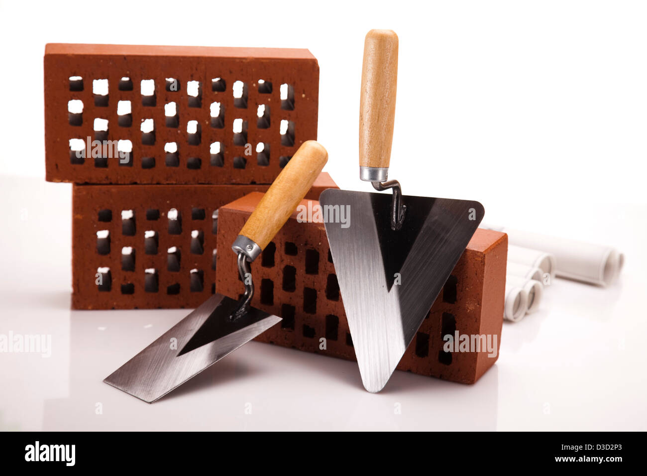 Bricks, trowel tool and Construction plans Stock Photo - Alamy