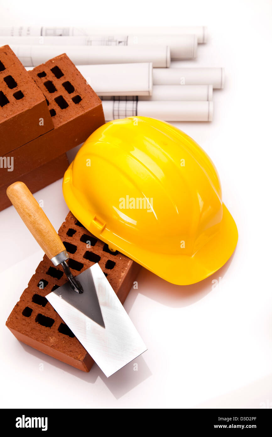 Bricks, trowel tool and Construction plans Stock Photo - Alamy