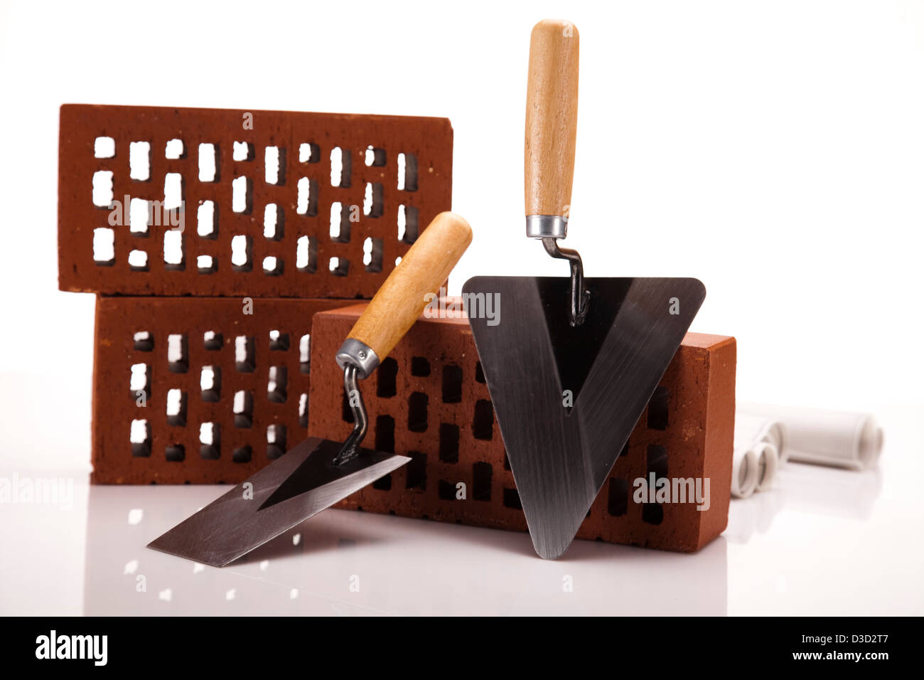 Bricks, trowel tool and Construction plans Stock Photo - Alamy