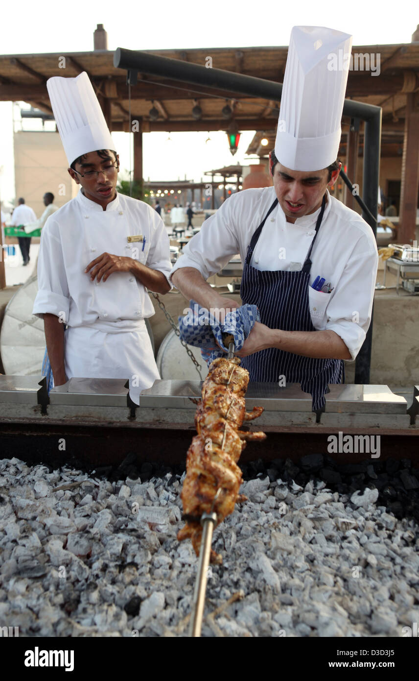 Dubai, United Arab Emirates, chef puts a skewer with Grillhaehnchen ...