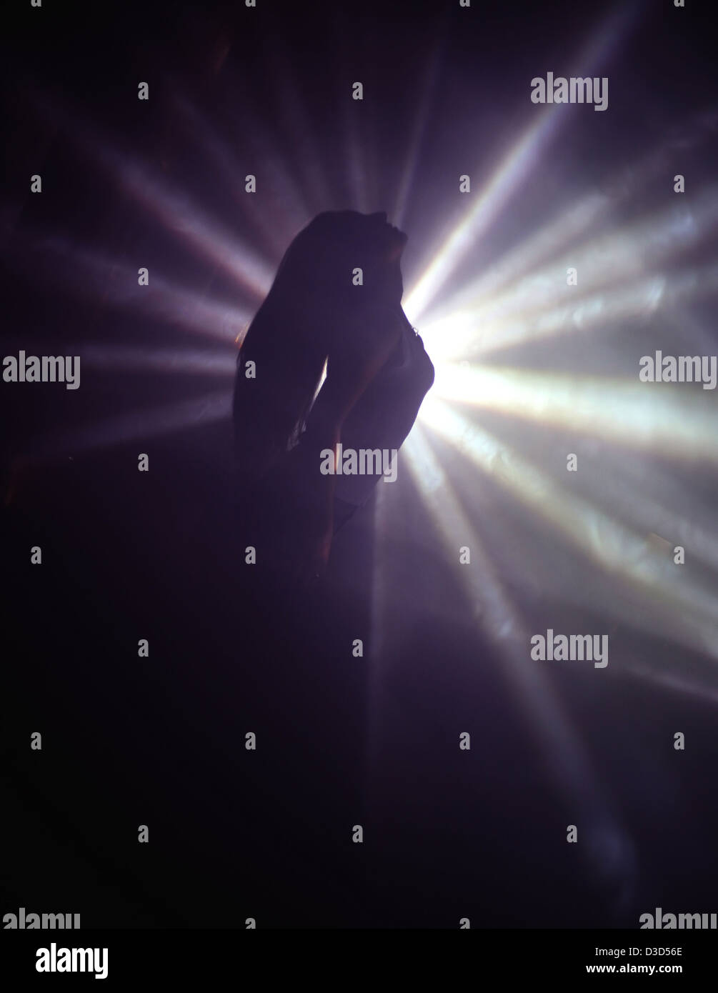 Silhouette of dancing girl in rays of light Stock Photo - Alamy