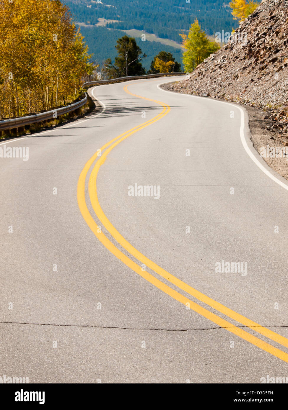 A rural mountain road with a winding "S" curve. Autumn landscape in ...