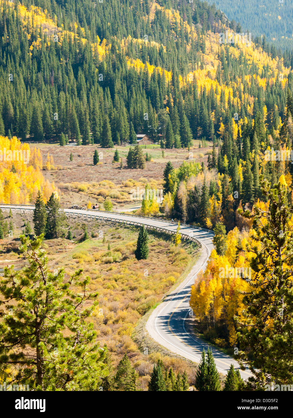A rural mountain road with a winding "S" curve. Autumn landscape in ...