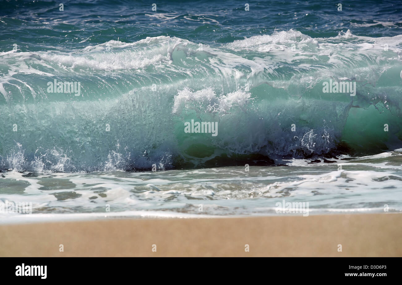 Blue coastal waves and sand Stock Photo - Alamy
