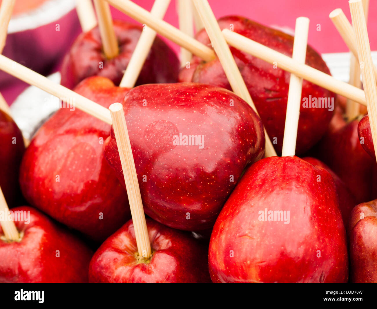 Red apples with stick ready to be dipped in caramel Stock Photo - Alamy