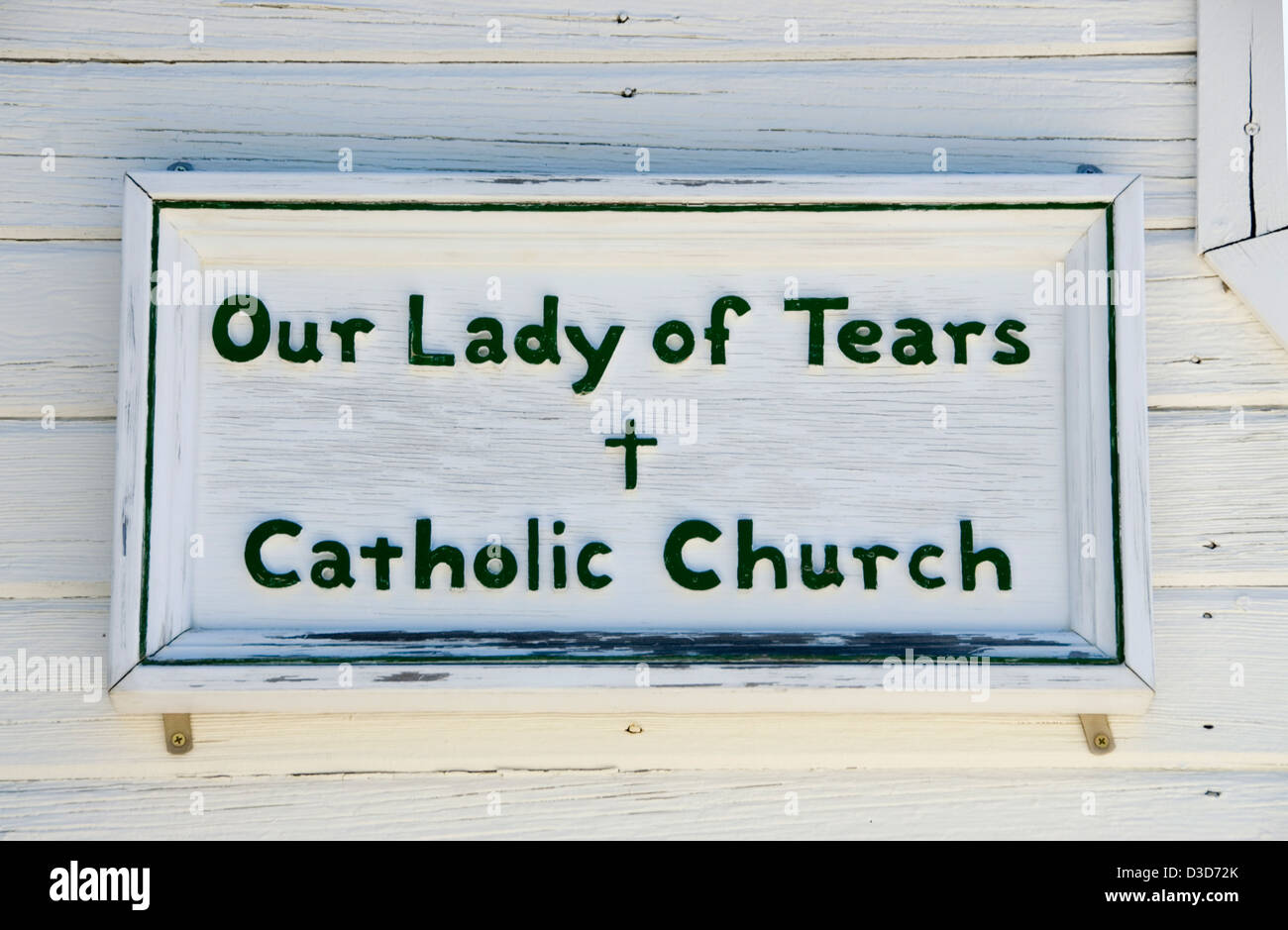 Sign on the exterior wall of the Our Lady of Tears Catholic Church in ...