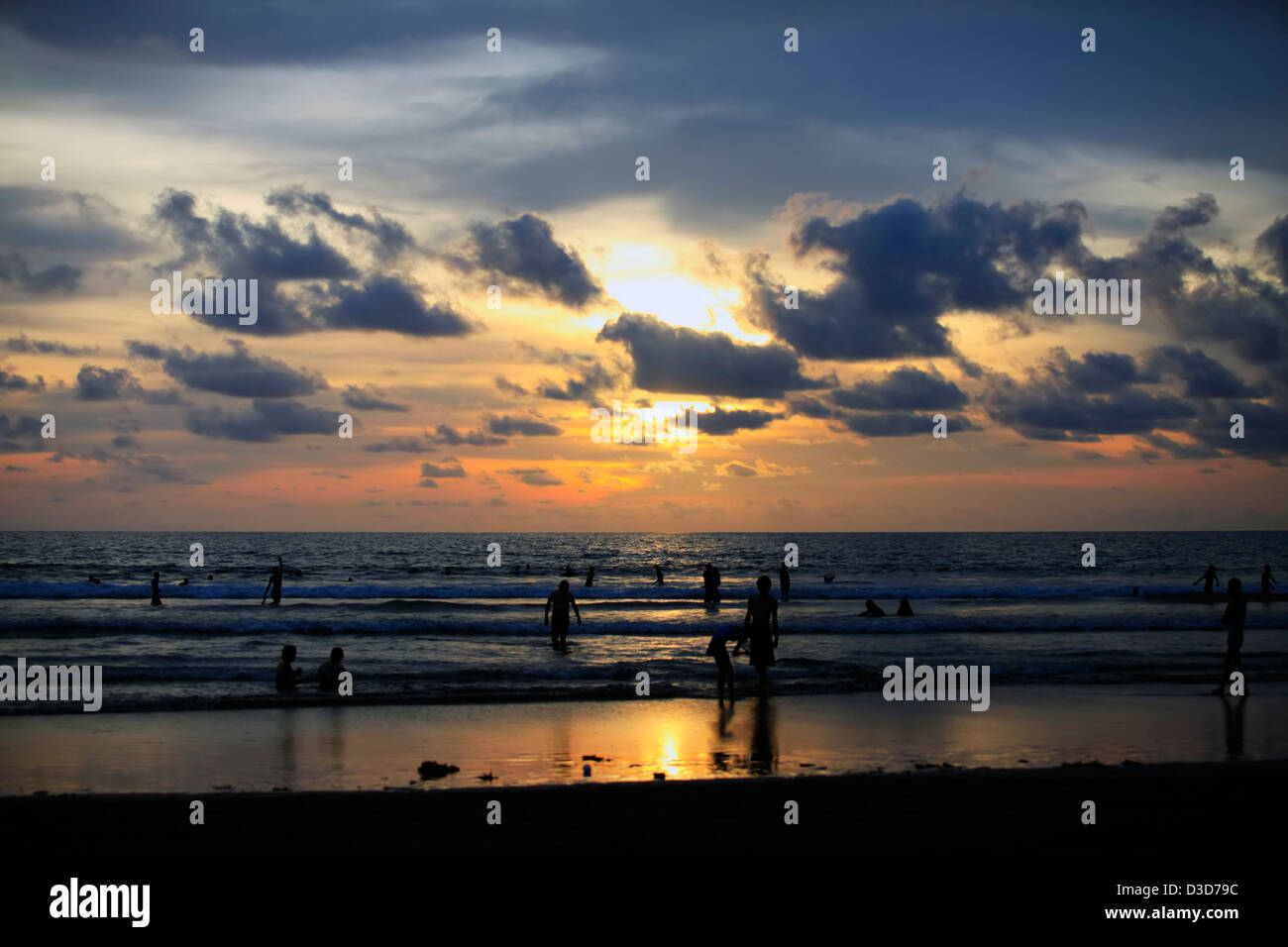 People bathe at ocean on a sunset Stock Photo - Alamy