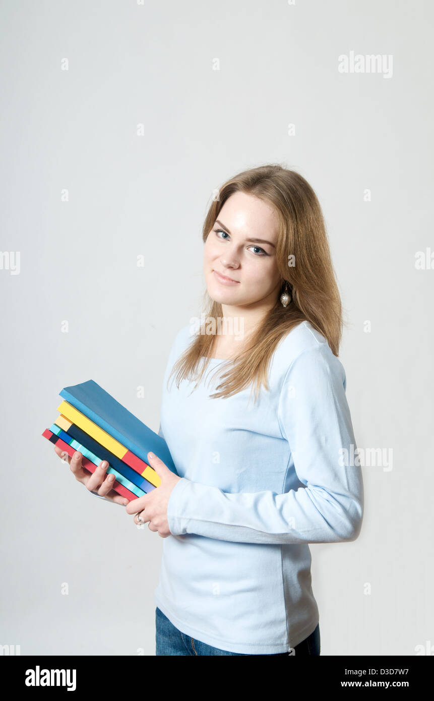 Beautiful girl with textbooks with white background Stock Photo - Alamy