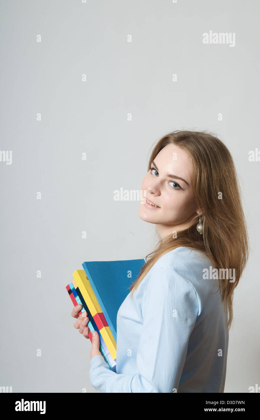 Beautiful girl with textbooks with white background Stock Photo - Alamy