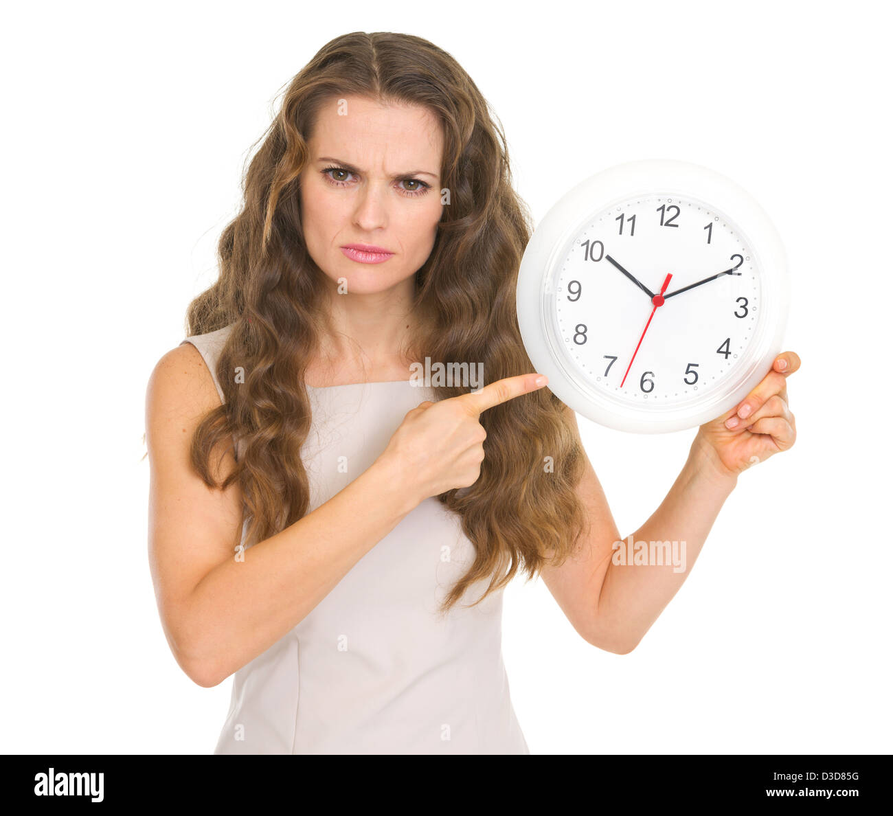 Concerned young woman pointing on clock Stock Photo - Alamy