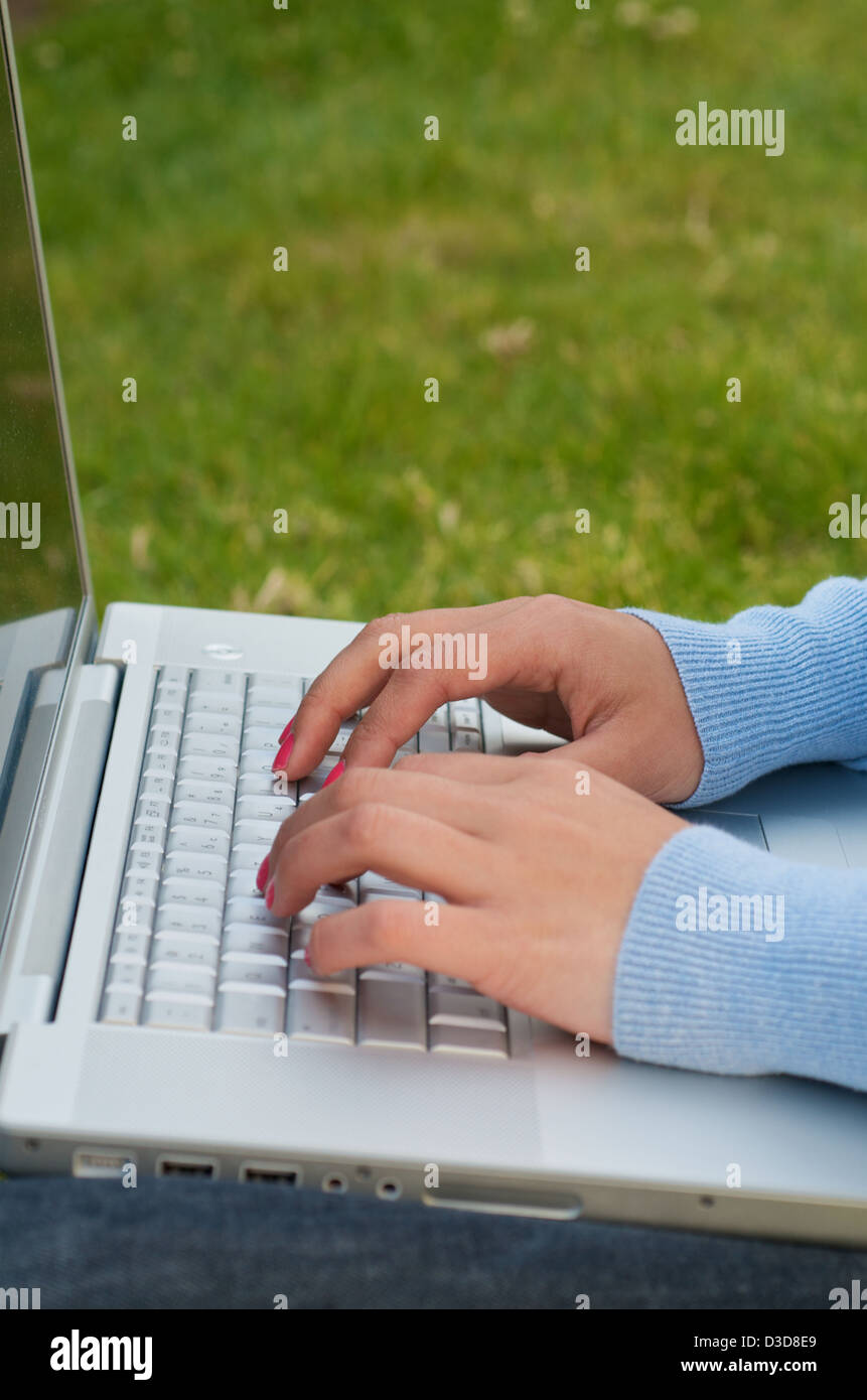 Woman typing and studying outdoor on laptop in the nature Stock Photo ...