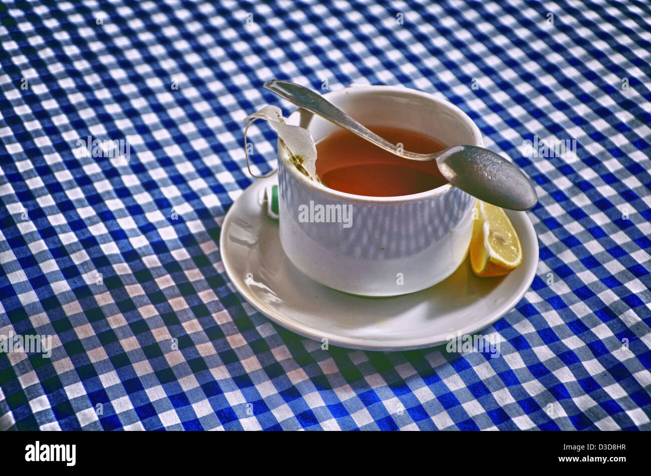 Tea. White porcelain cup of tea arranged with spoon, lemon and plate on ...