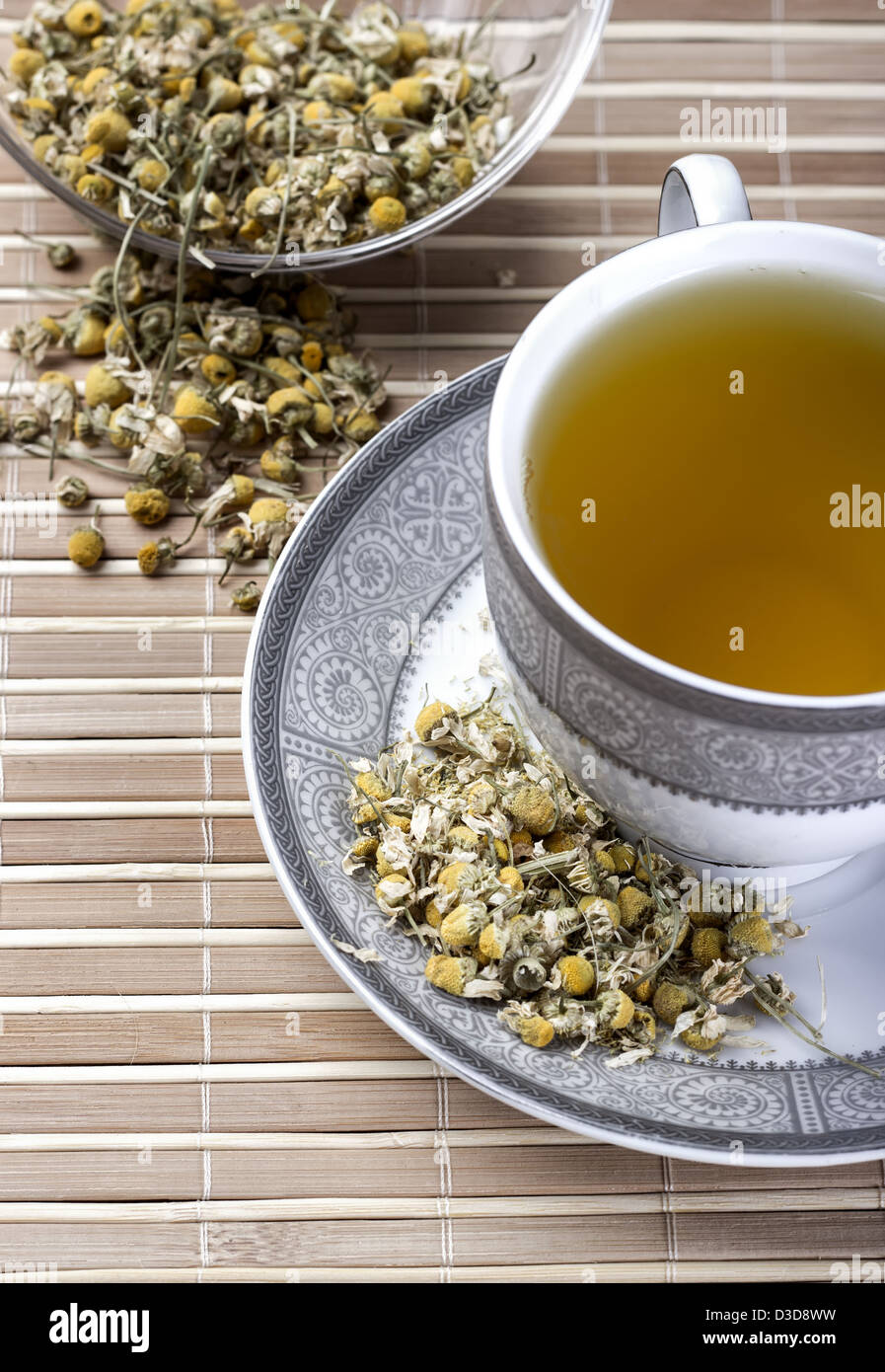 Dried camomile flowers surrounding fresh up of camomile tea Stock Photo ...