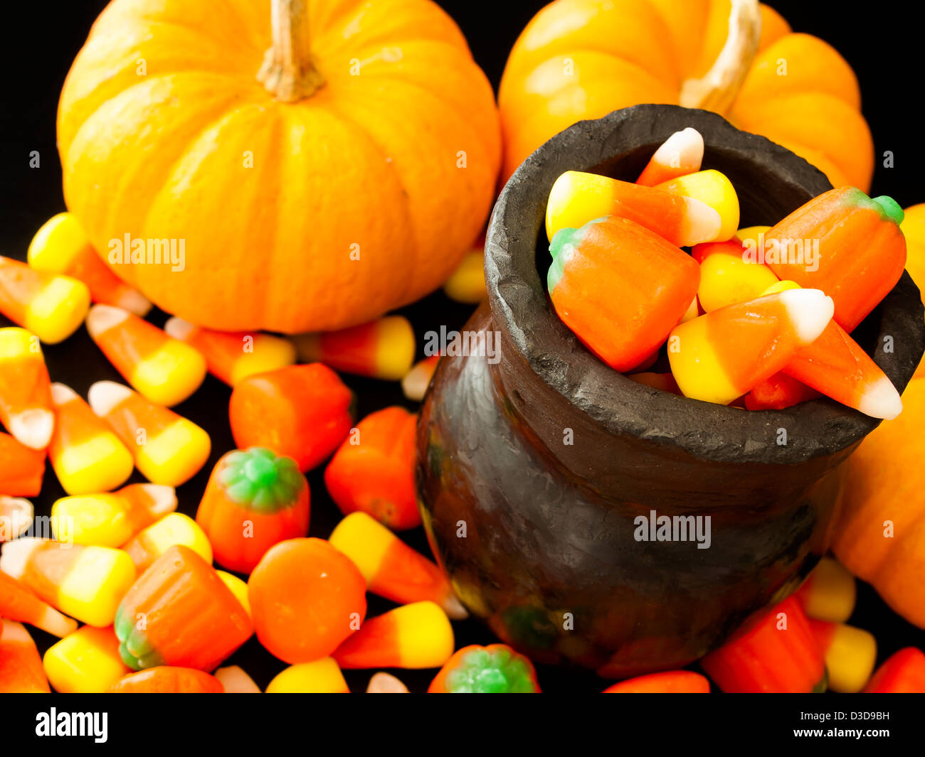 Halloween candies spilled on black background Stock Photo - Alamy
