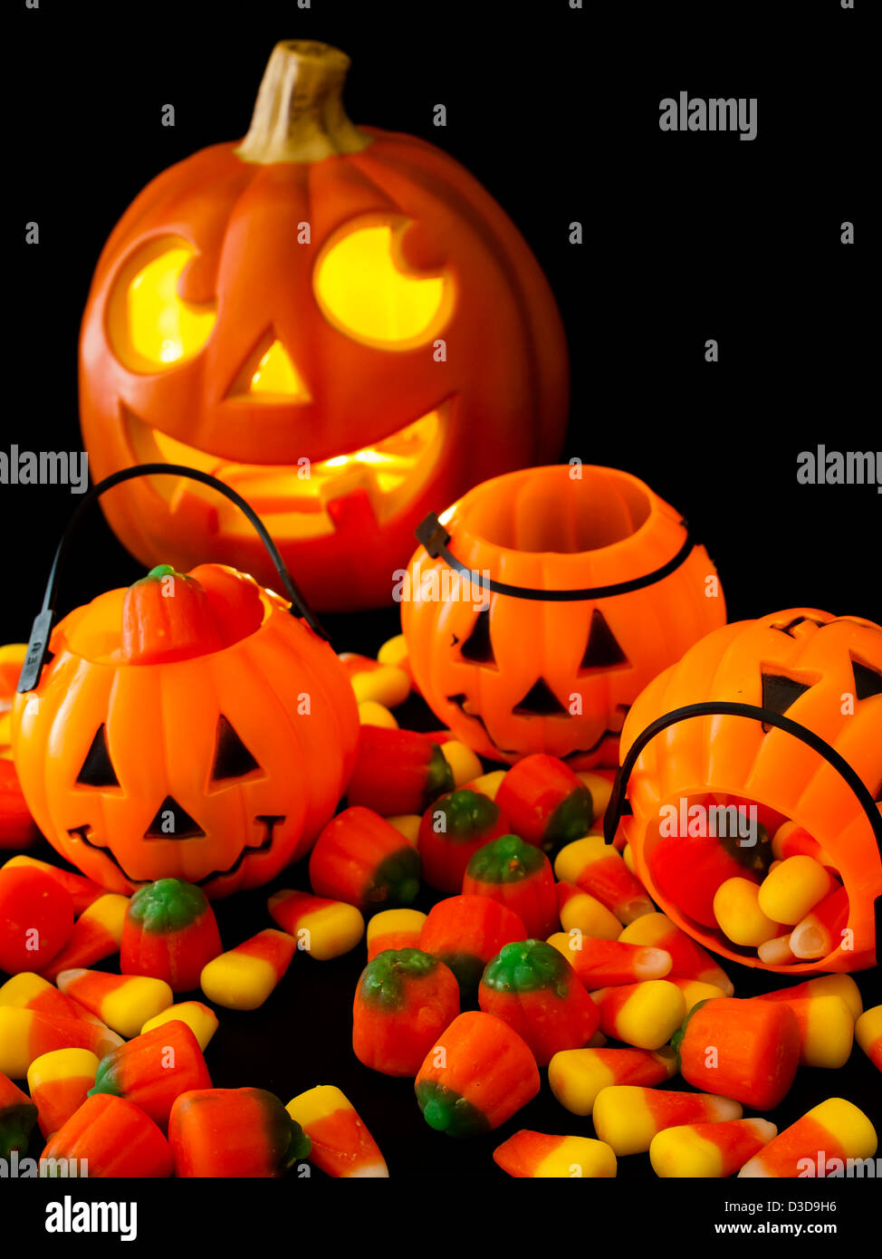 Halloween candies spilled on black background Stock Photo - Alamy