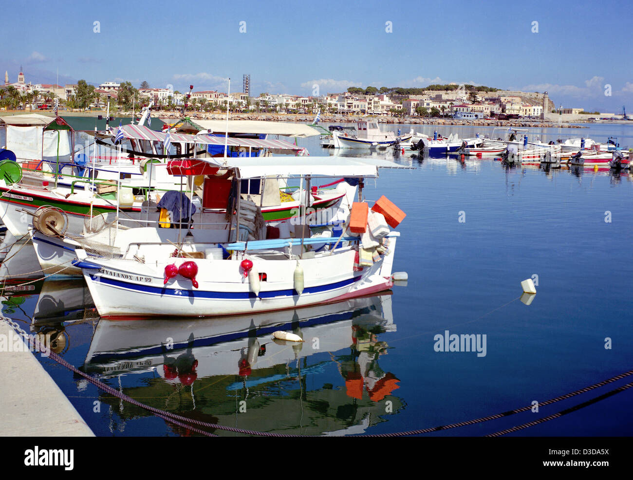 A line-up of fishing boats next to the quayside fish market in Rethymno ...