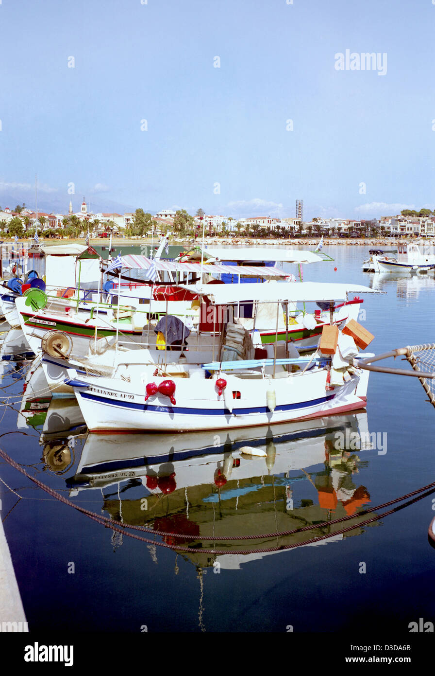 A line-up of fishing boats next to the quayside fish market in Rethymno ...