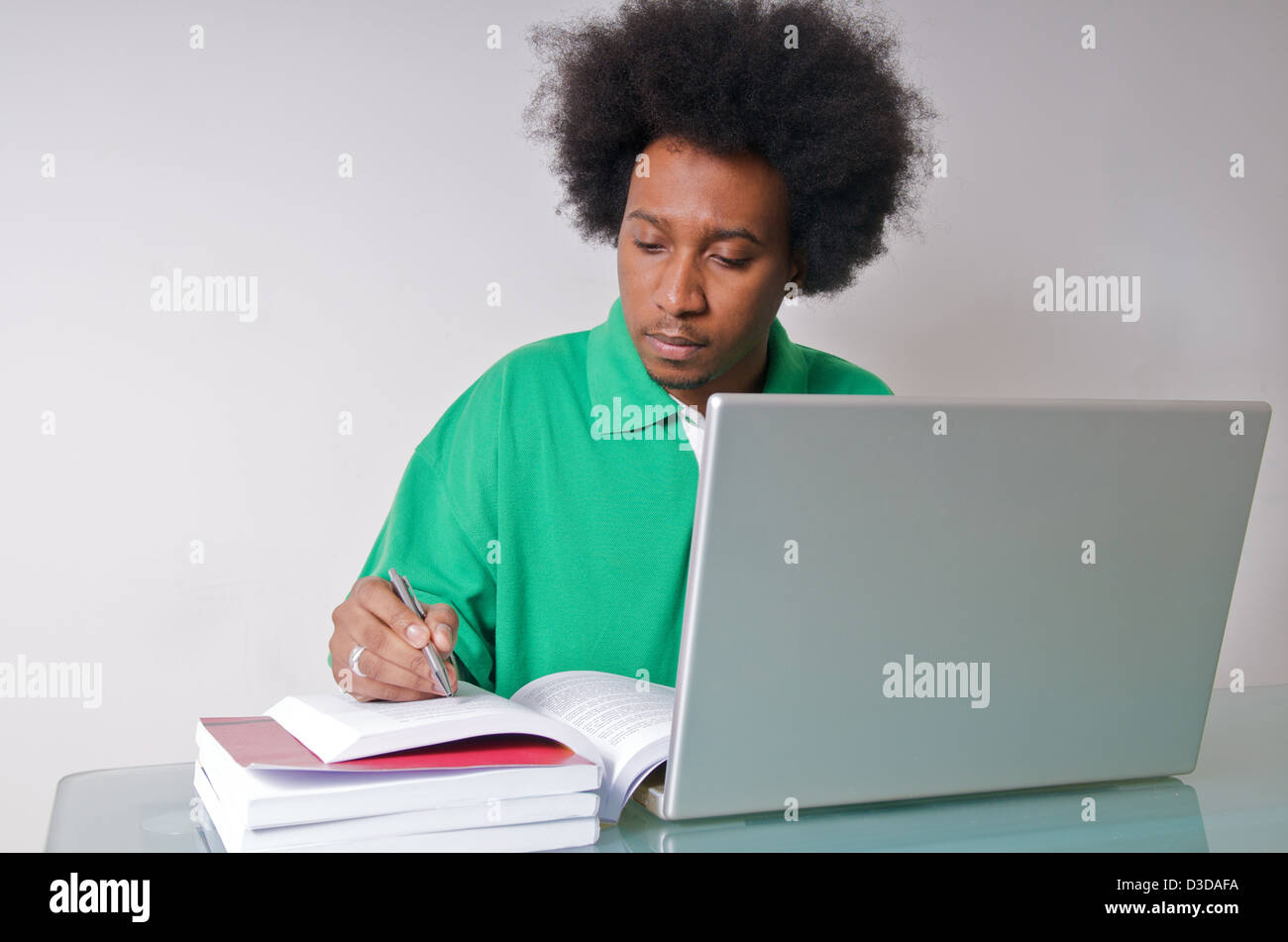 African American student studying with latop and textbooks Stock Photo ...