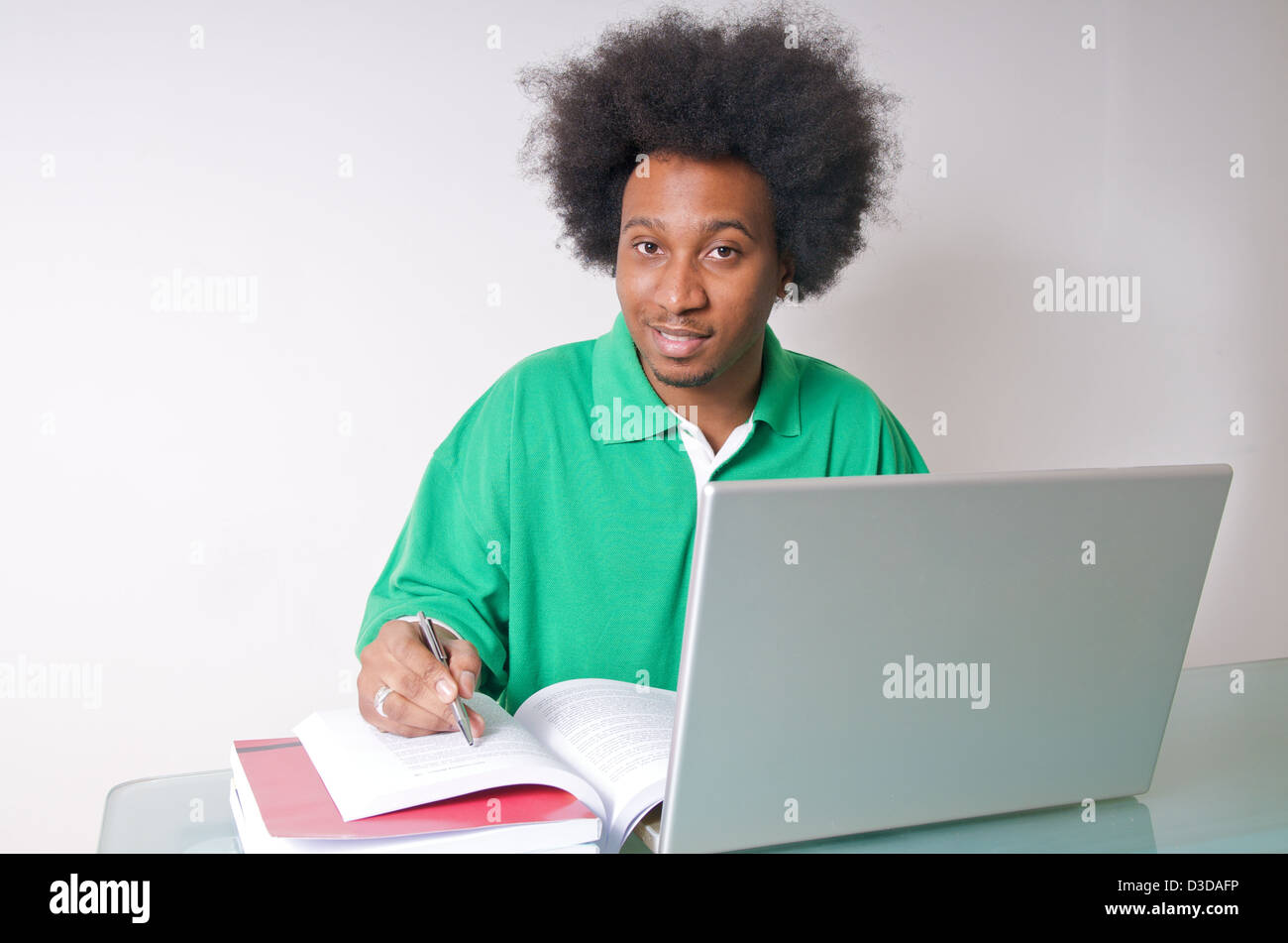 African American student studying with latop and textbooks Stock Photo ...