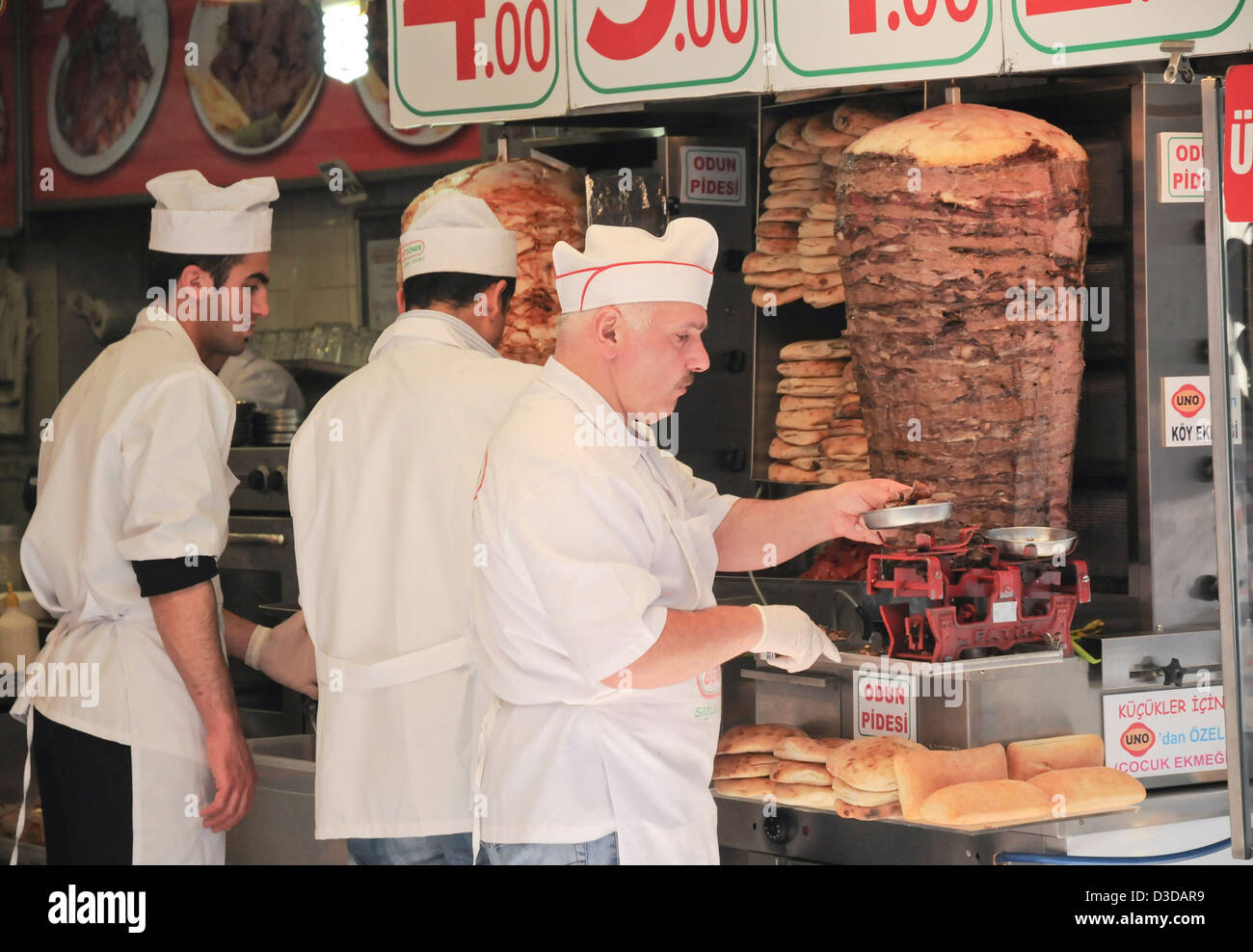 Döner meat being scrapped from the spit for a kebab Stock Photo - Alamy