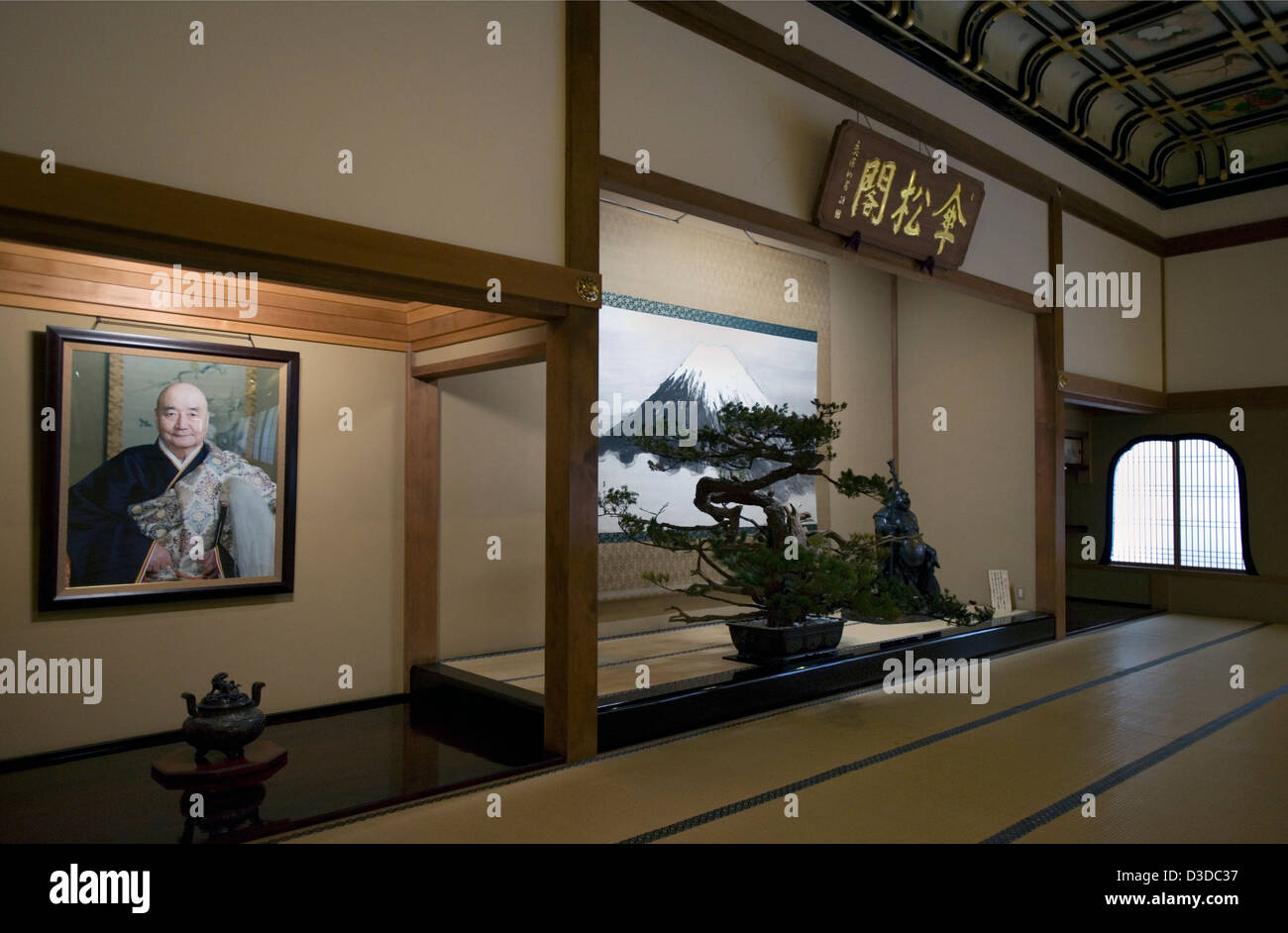 Tokonoma display of Mount Fuji scroll, bonsai tree and Buddha statue of ...