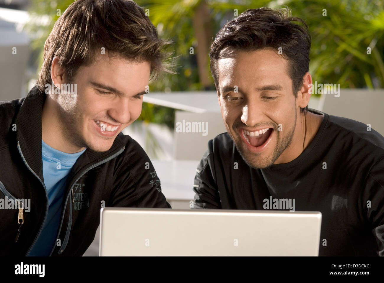 Two young men in front of the laptop Stock Photo - Alamy