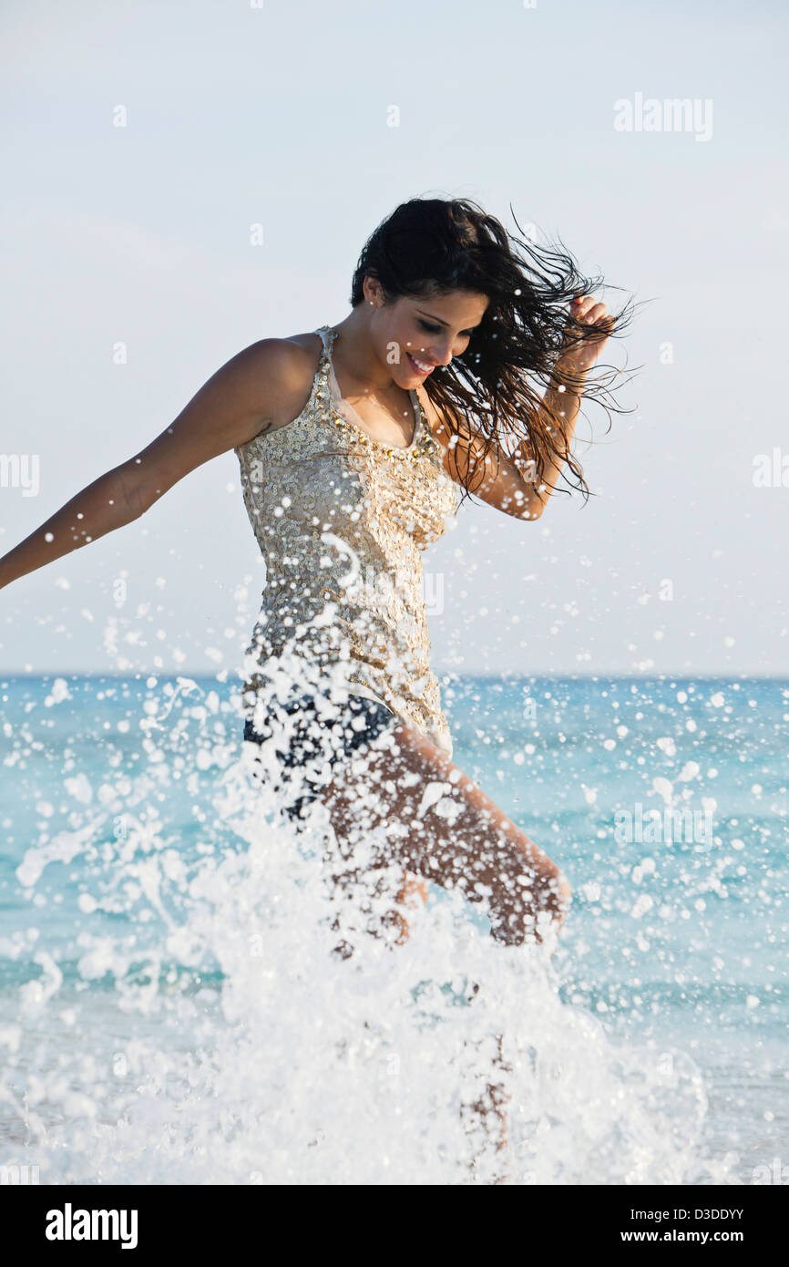 Woman enjoying in water on the beach Stock Photo - Alamy