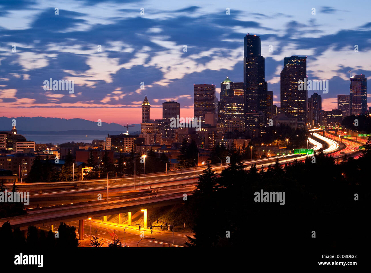 Seattle skyline sunset with city lights and car traffic on I-5 Stock ...