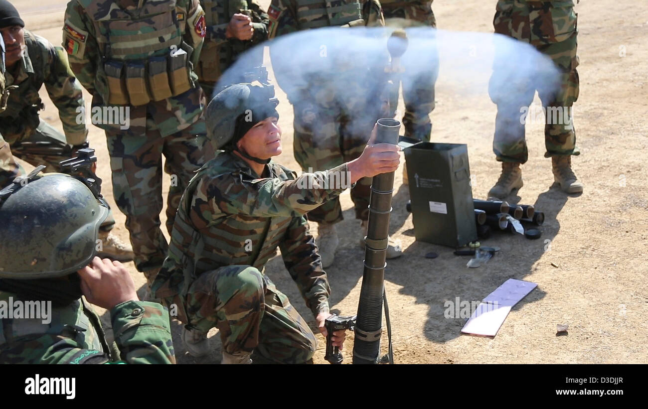 An Afghan commando practices firing a a 60mm mortar during weapons ...