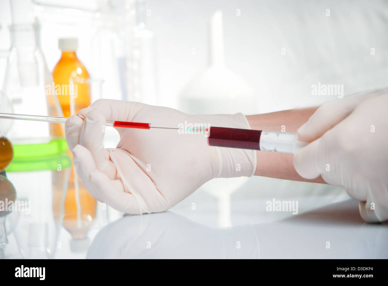 doctor taking some blood samples, using pipette and small test tube ...