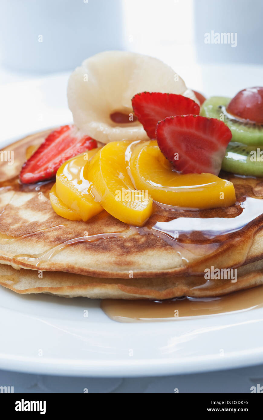Breakfast pancakes with fruit topping and syrup Stock Photo - Alamy
