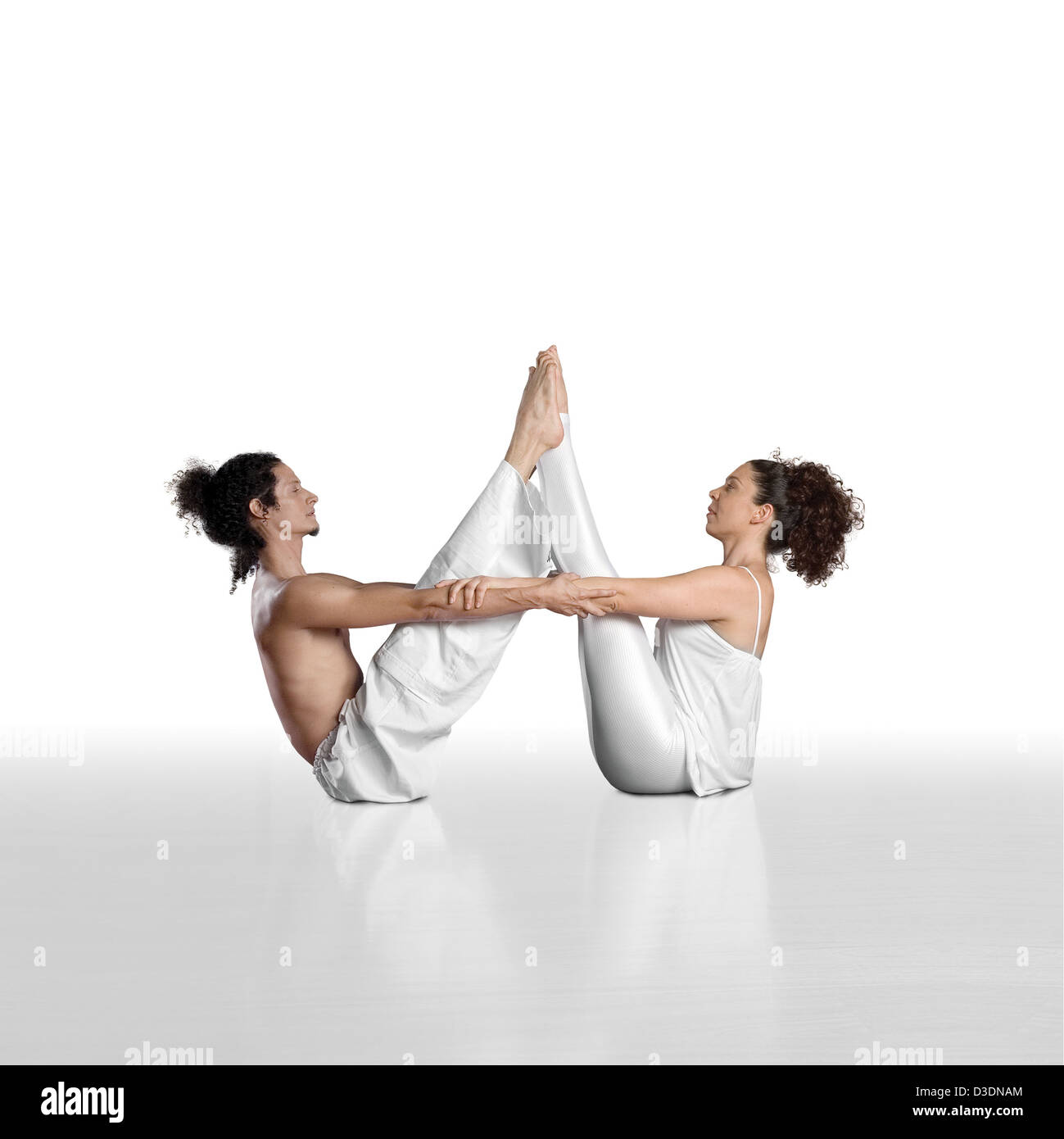 Young couple practicing Pilates on white background Stock Photo - Alamy