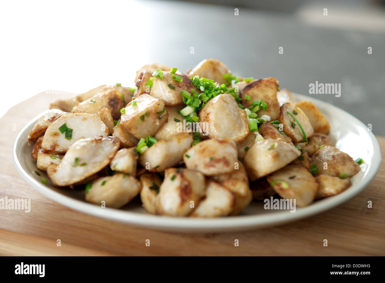 Fried potato dish with chopsticks Stock Photo - Alamy