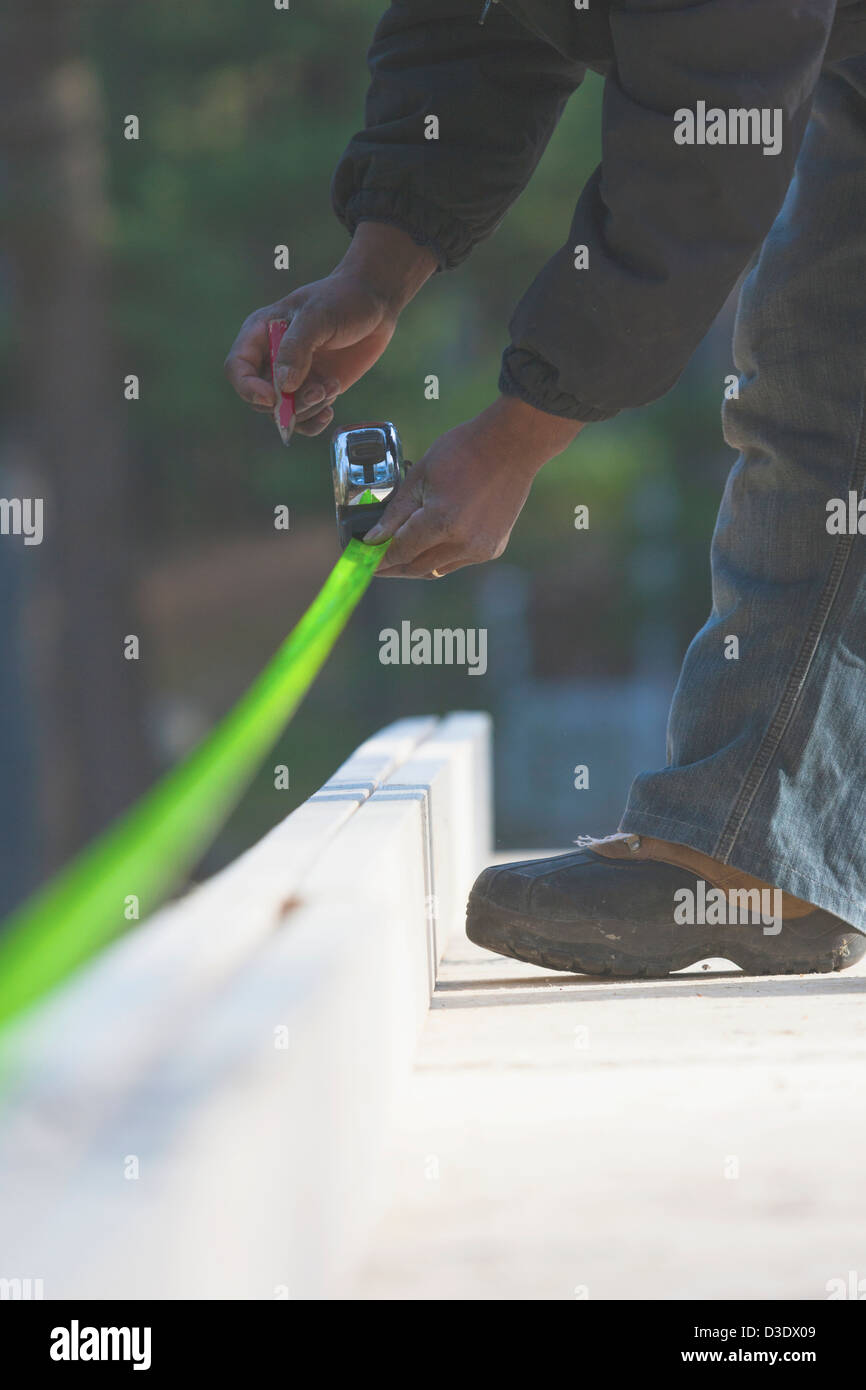 Carpenter measuring board length Stock Photo - Alamy