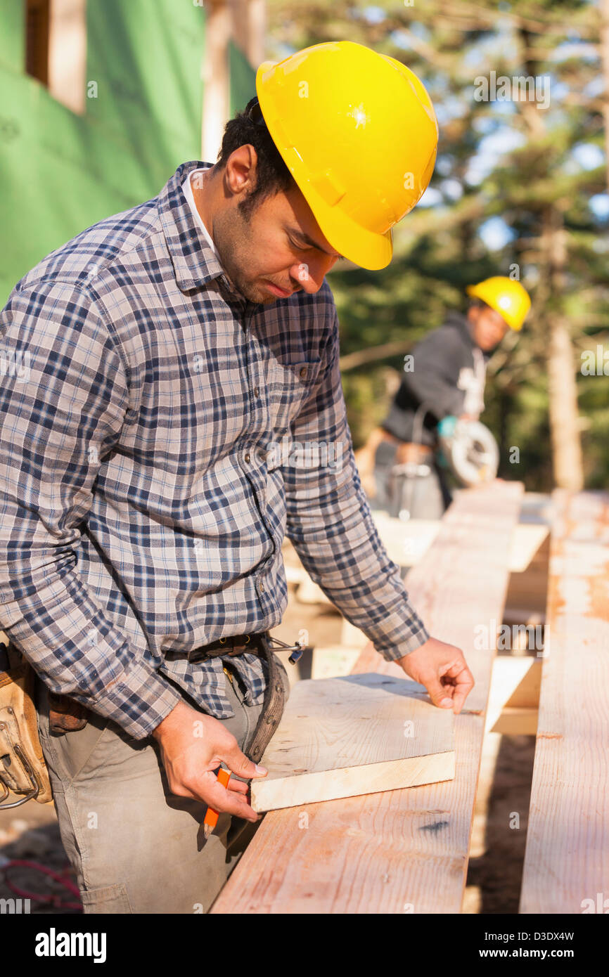 Carpenter preparing bevel cut for a rafter Stock Photo - Alamy